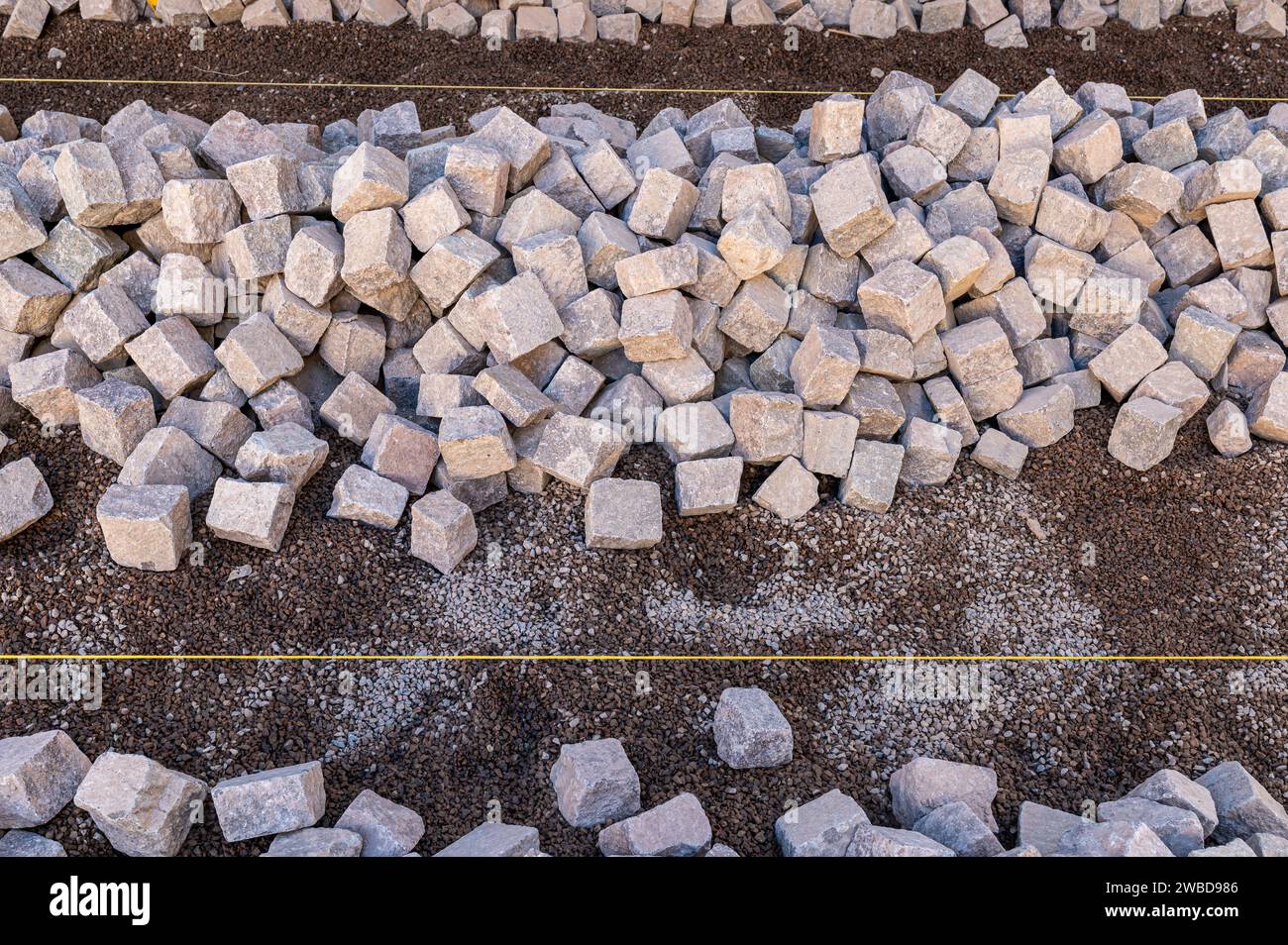 Resurfacing the road surface, manual laying of porphyry cubes on the ...