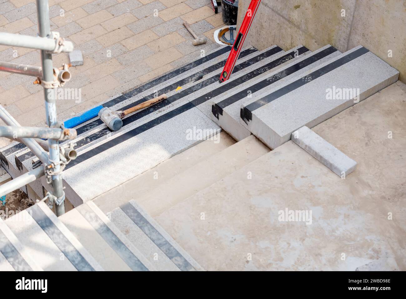 Concrete steps under construction as a team of builders install heavy ...