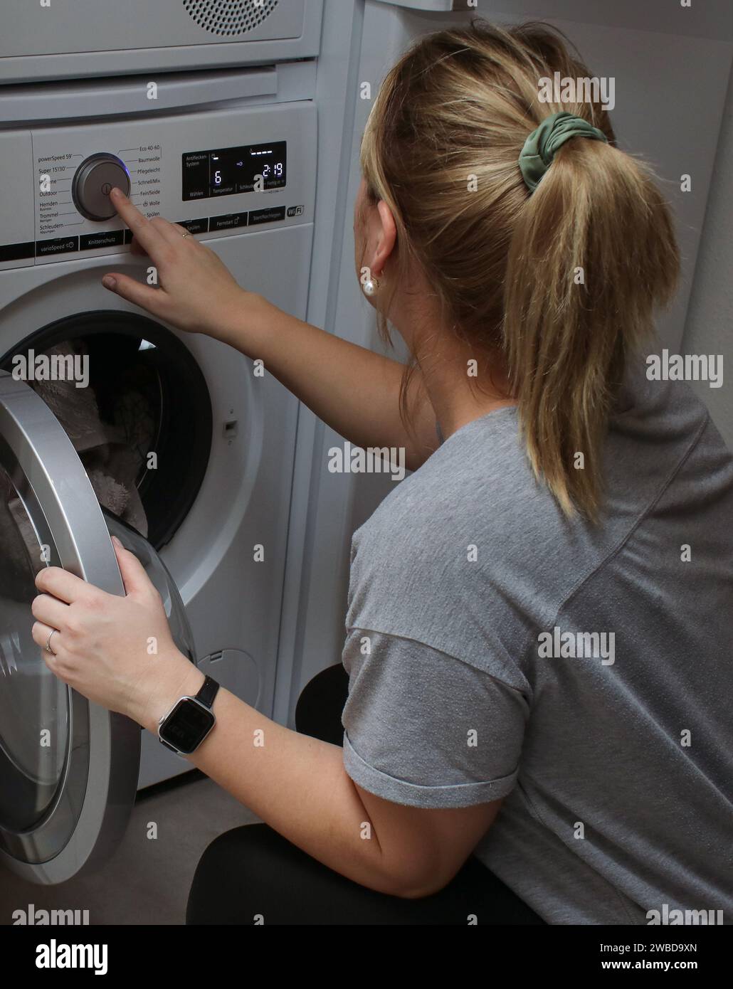 Doing up a button hi-res stock photography and images - Alamy