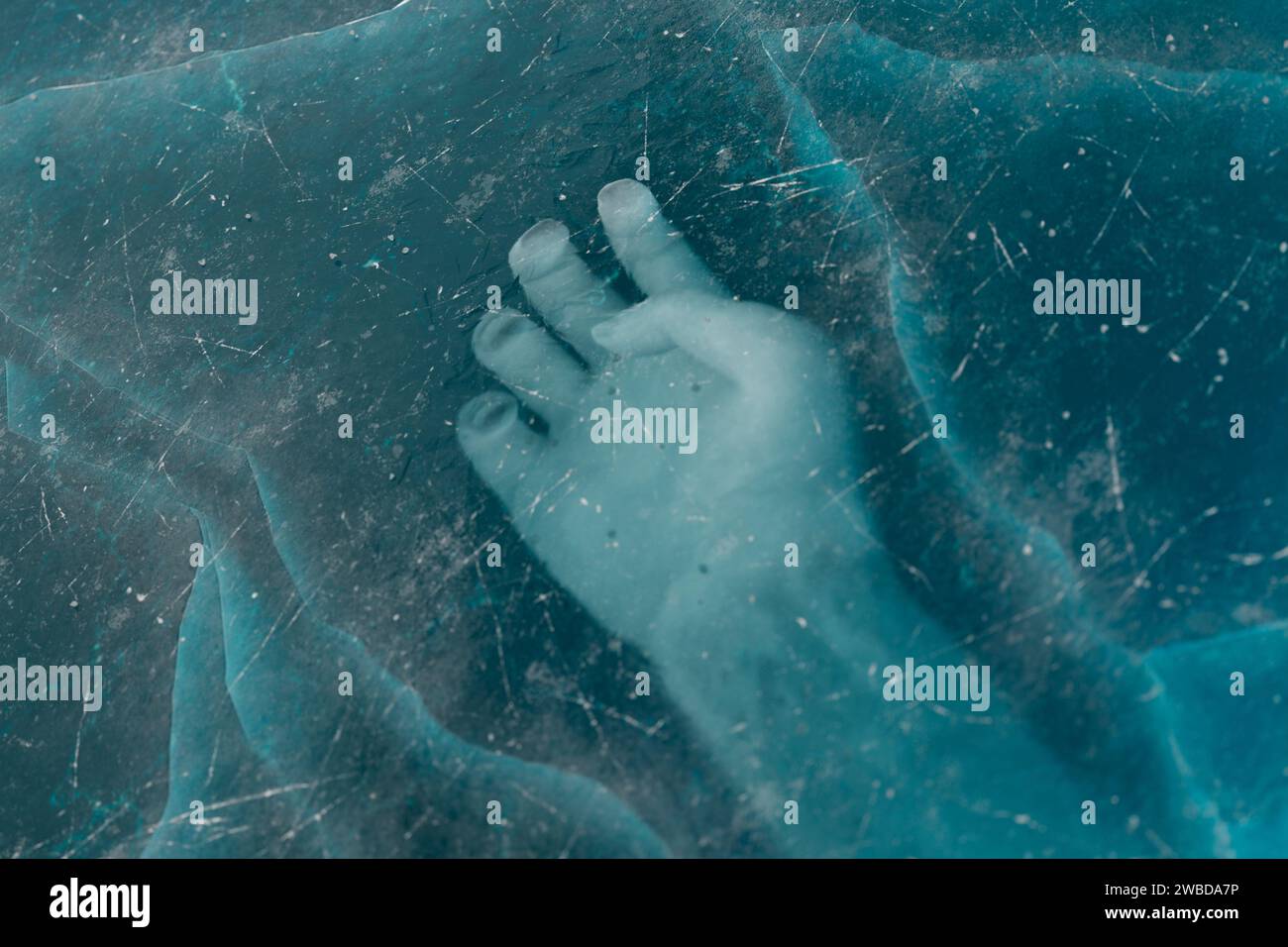 A close-up depiction of a single human hand pressing against a semi ...