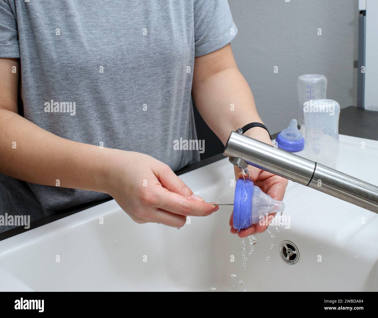 Mother cleaning baby milk bottles hi-res stock photography and images ...