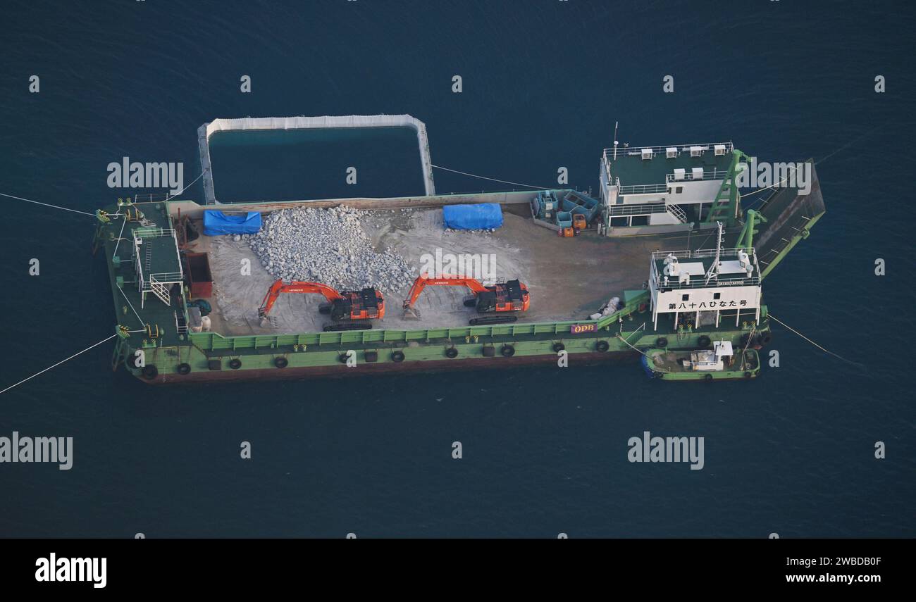 An aerial photo taken from a jetliner shows a barge ship operated by ...