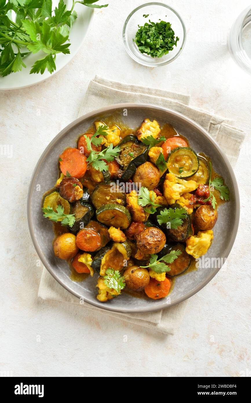 Vegetarian stew with mixed vegetables on plate over light background ...
