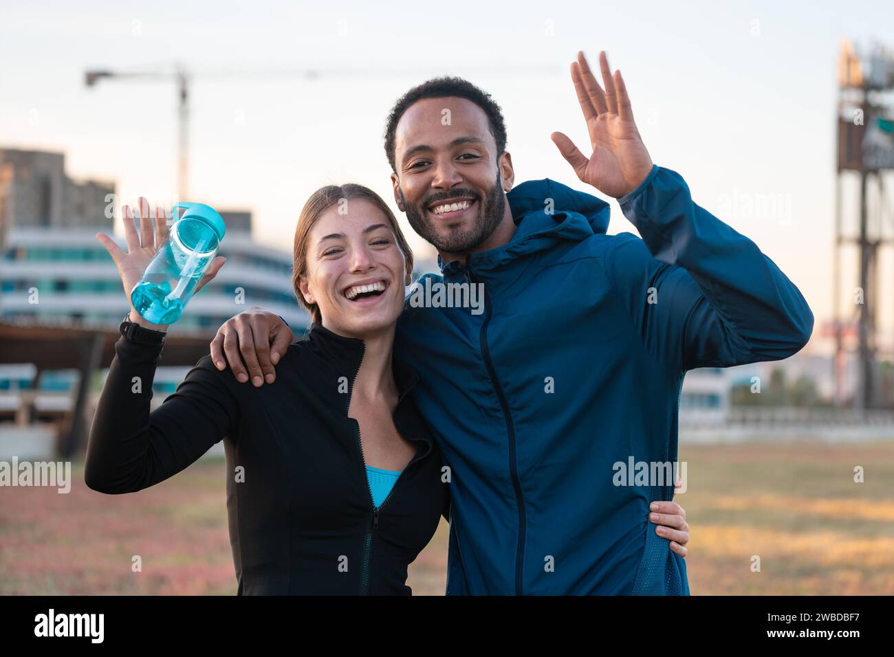 Portrait happy young couple ready to exercise outdoors Stock Photo - Alamy