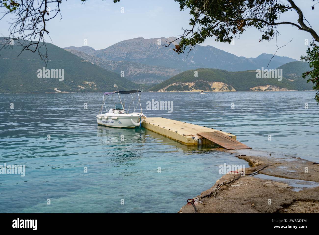 Boat moored at jetty at Ammoglossa Beach on the greek ionian island of ...