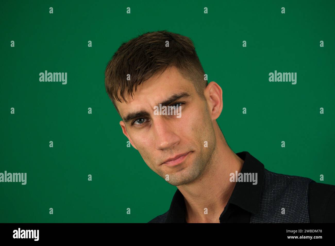 emotions of a handsome man guy on a green background chromakey close-up ...