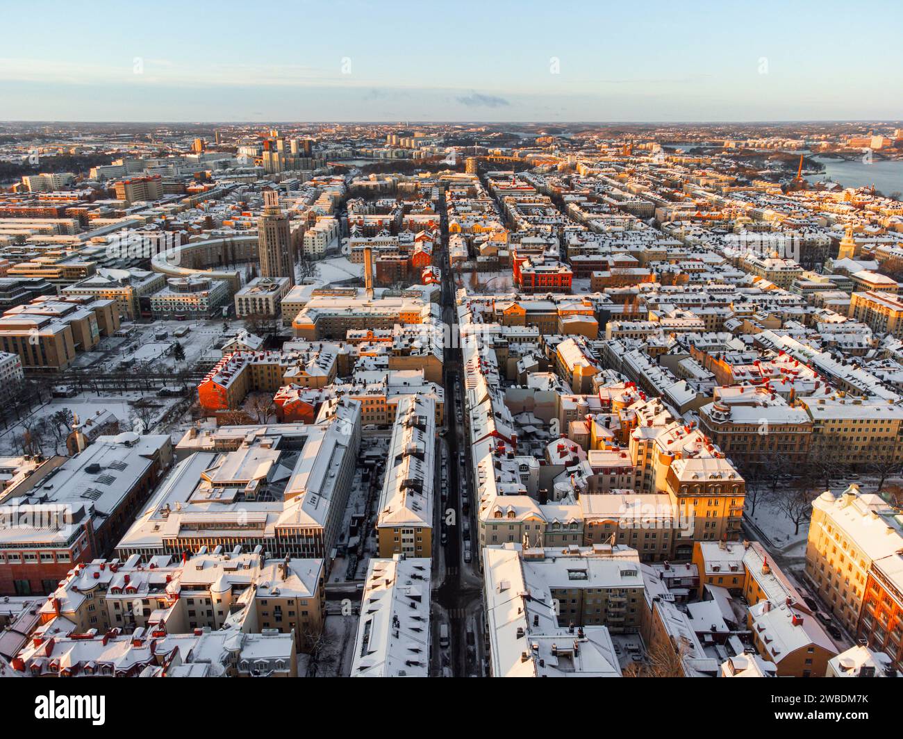 A beautiful sunrise over the skyline of Stockholm in winter, with snowy ...