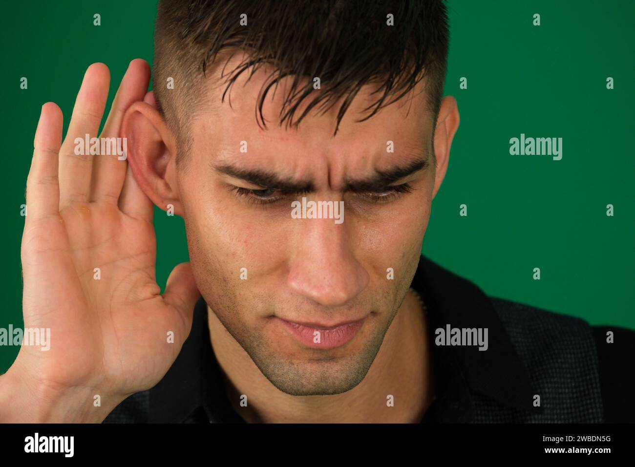 The deaf young man put his hand to his ear, listened. High quality ...