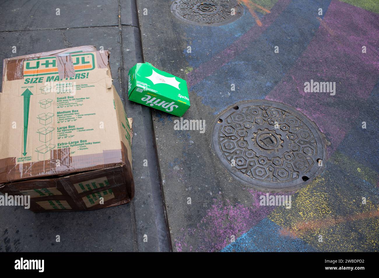 A cardboard box on the side of the street in front of a sidewalk in New ...