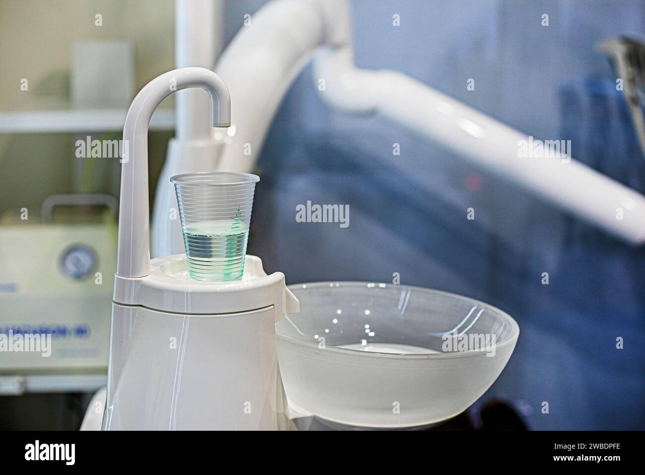 disposable cup with liquid for rinsing teeth in a dental office on a ...