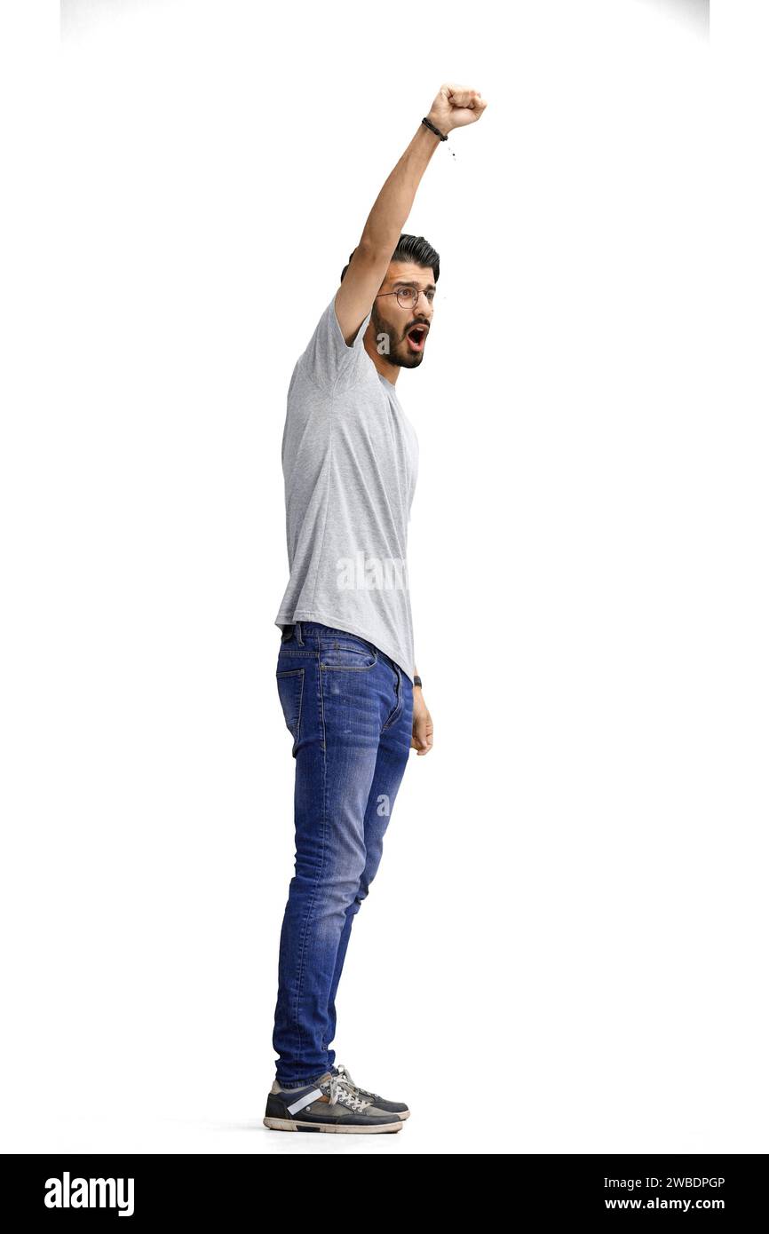 A man, on a white background, in full height, raised his hand Stock ...