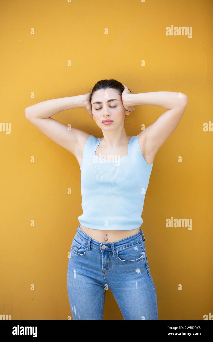 Beautiful woman hands on side of head Stock Photo - Alamy