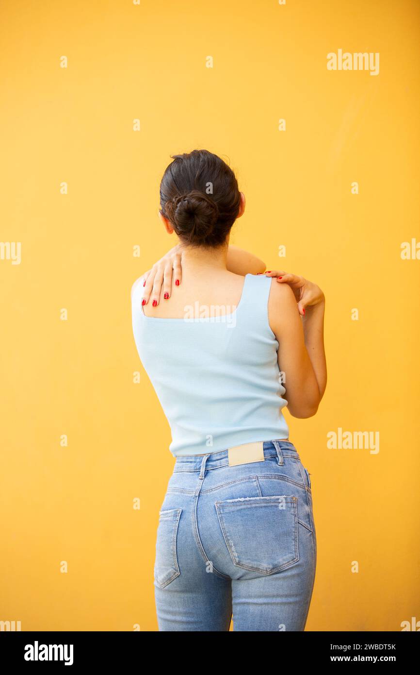 Rear view woman hands touching back Stock Photo - Alamy