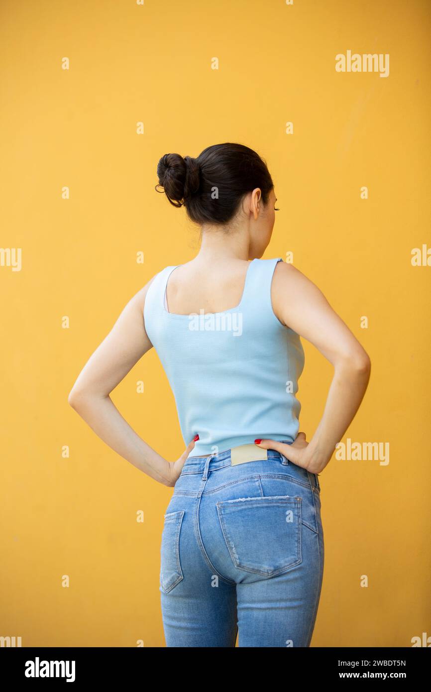 Rear view woman hands on hips looking away Stock Photo - Alamy