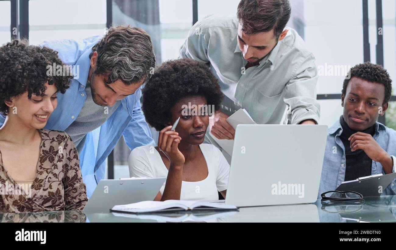 Happy young female employee discussing online project, showing computer ...
