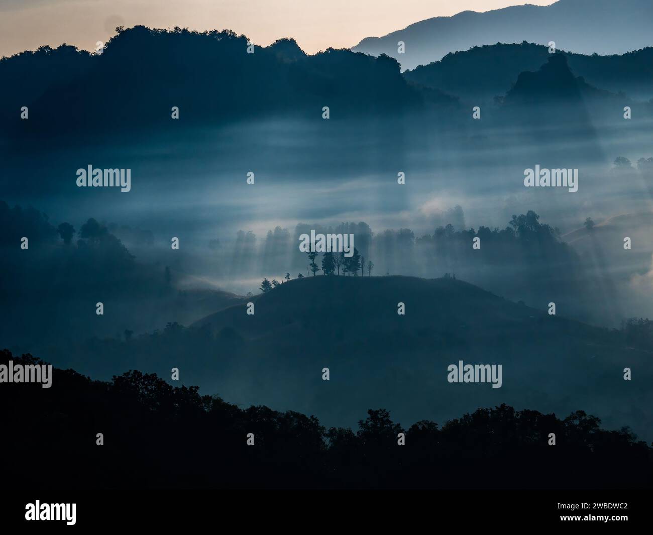 The rays of the morning sun through the fog in the mountains Stock ...