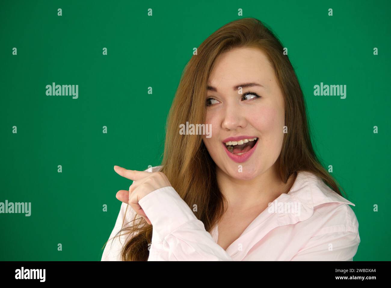 woman advertises something at mock-up blank white copy space on side up ...