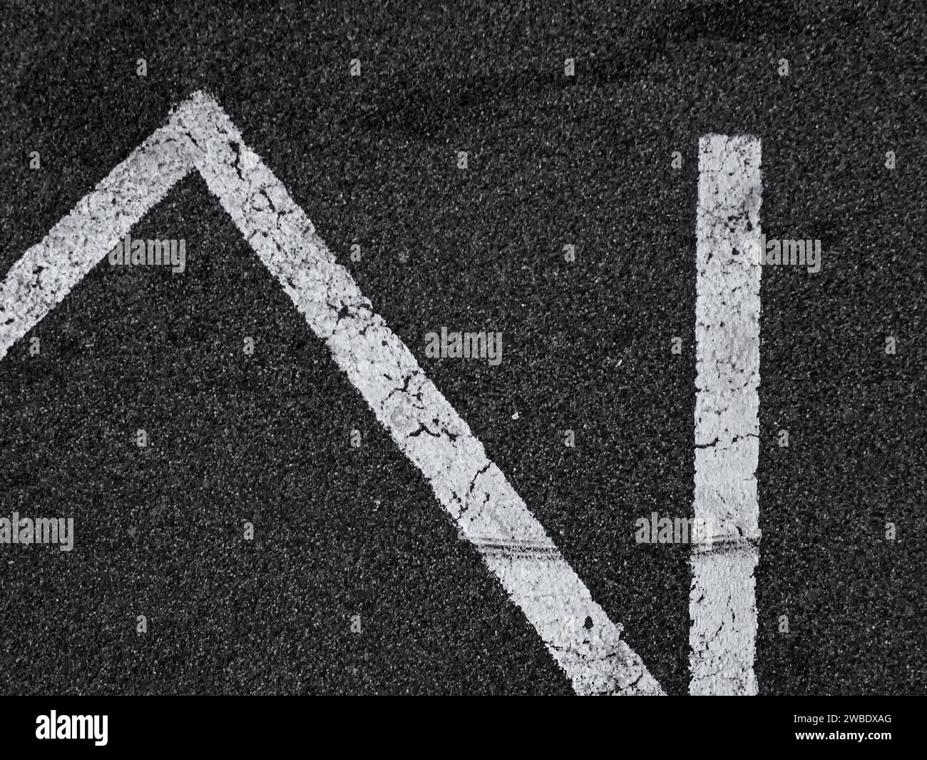 Close-up of a white, jagged marking on asphalt Stock Photo - Alamy