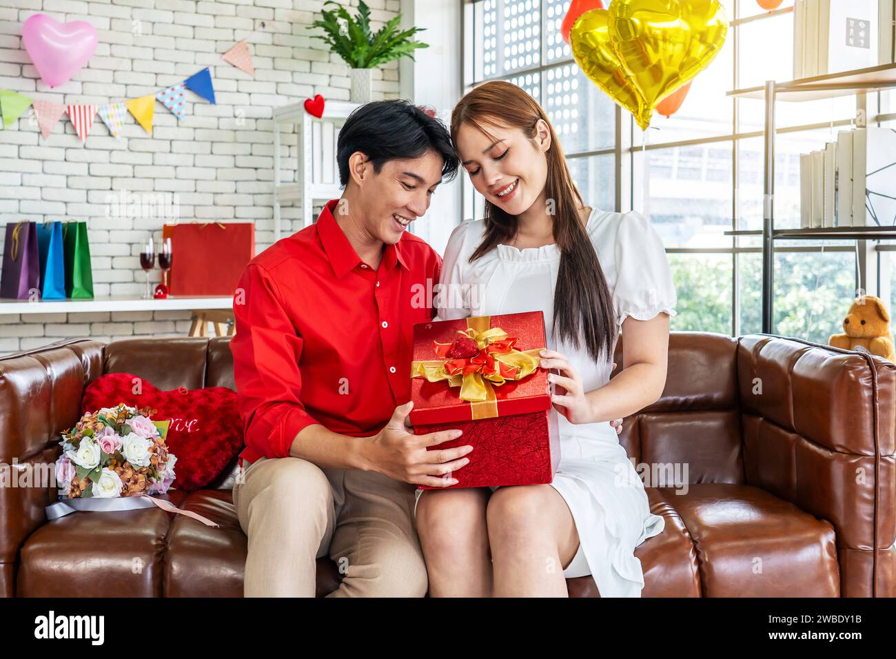 Excited young asian woman opening gift box receiving good unexpected ...