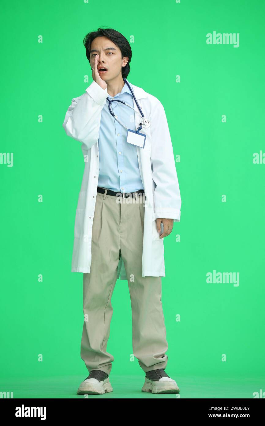 The doctor guy, on a green background, in full height, tells a secret ...