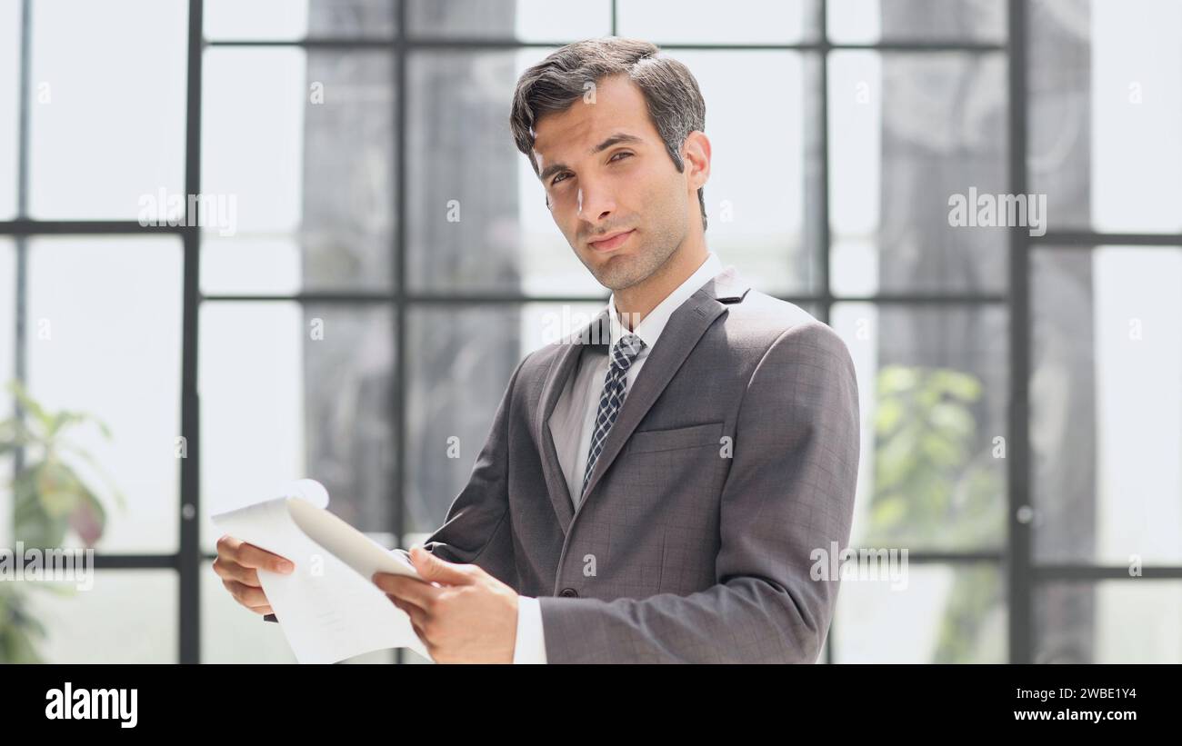 Portrait of a handsome young business man holding document folder Stock ...