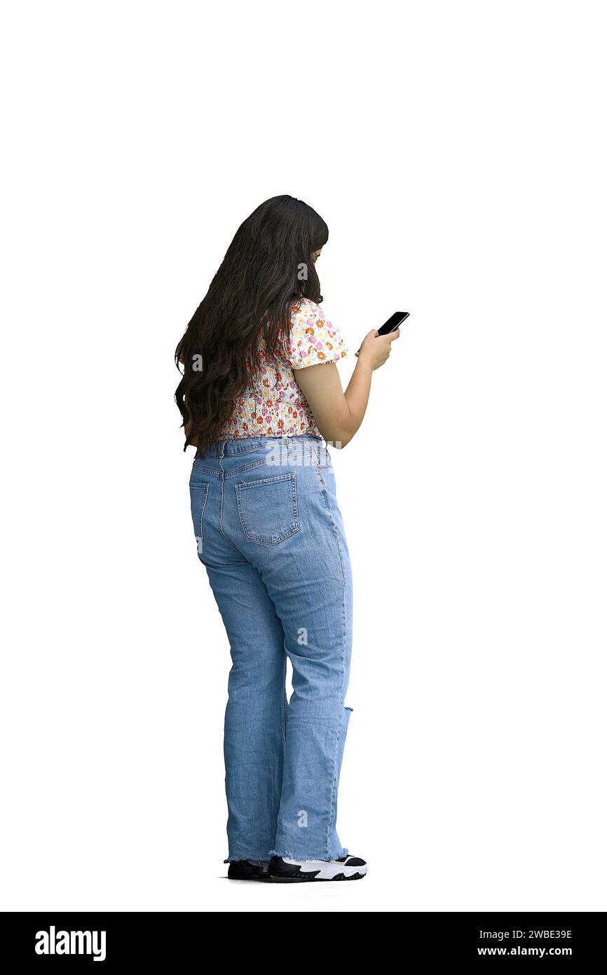 A woman, on a white background, full-length, with a phone, back view ...