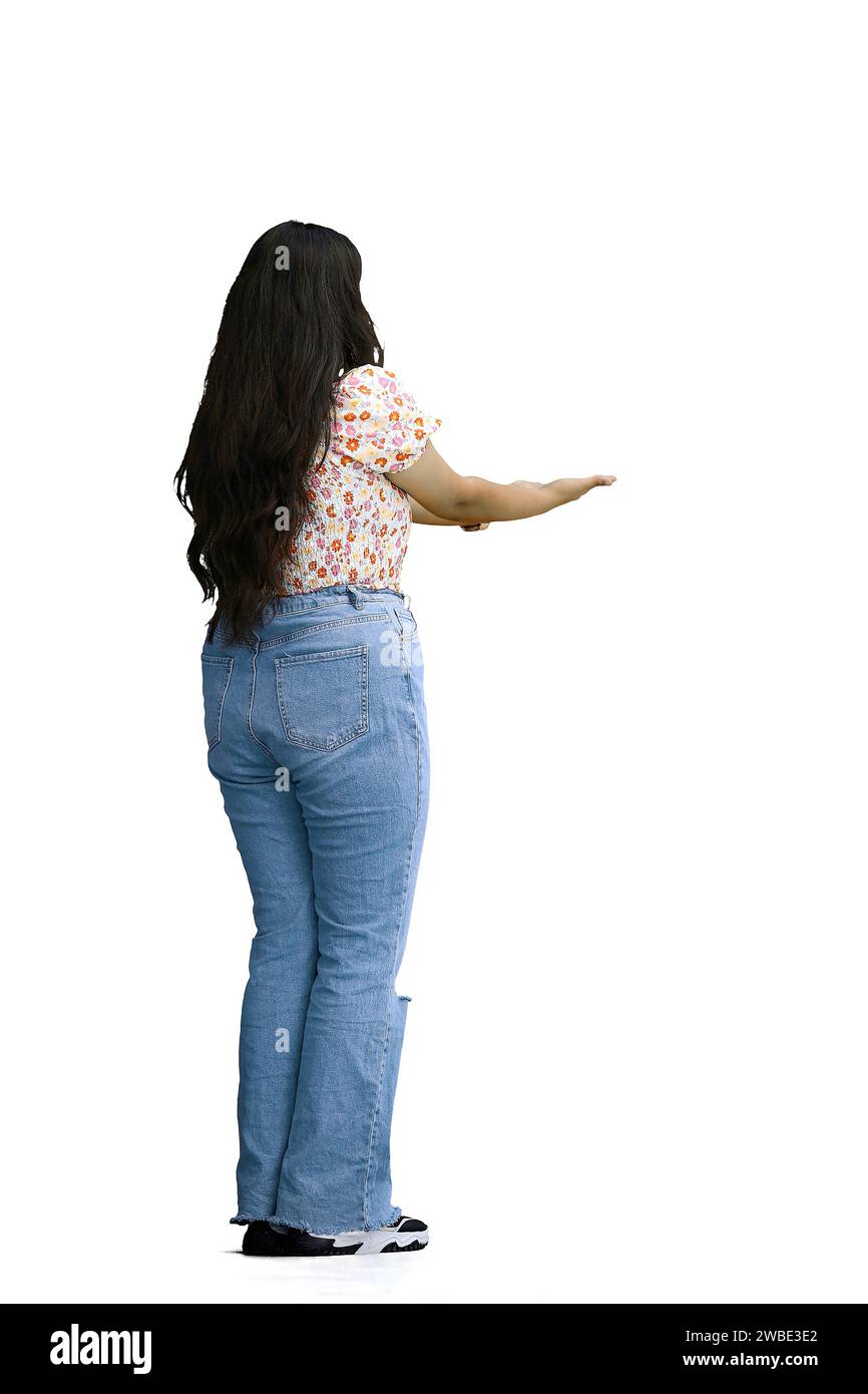 A woman, on a white background, full-length, points to the side, back ...