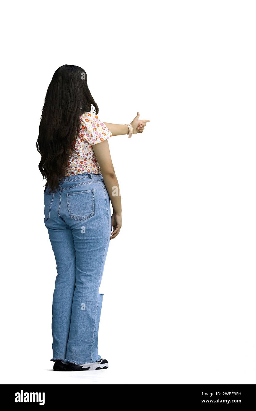 A woman, on a white background, full-length, points to the side, back ...