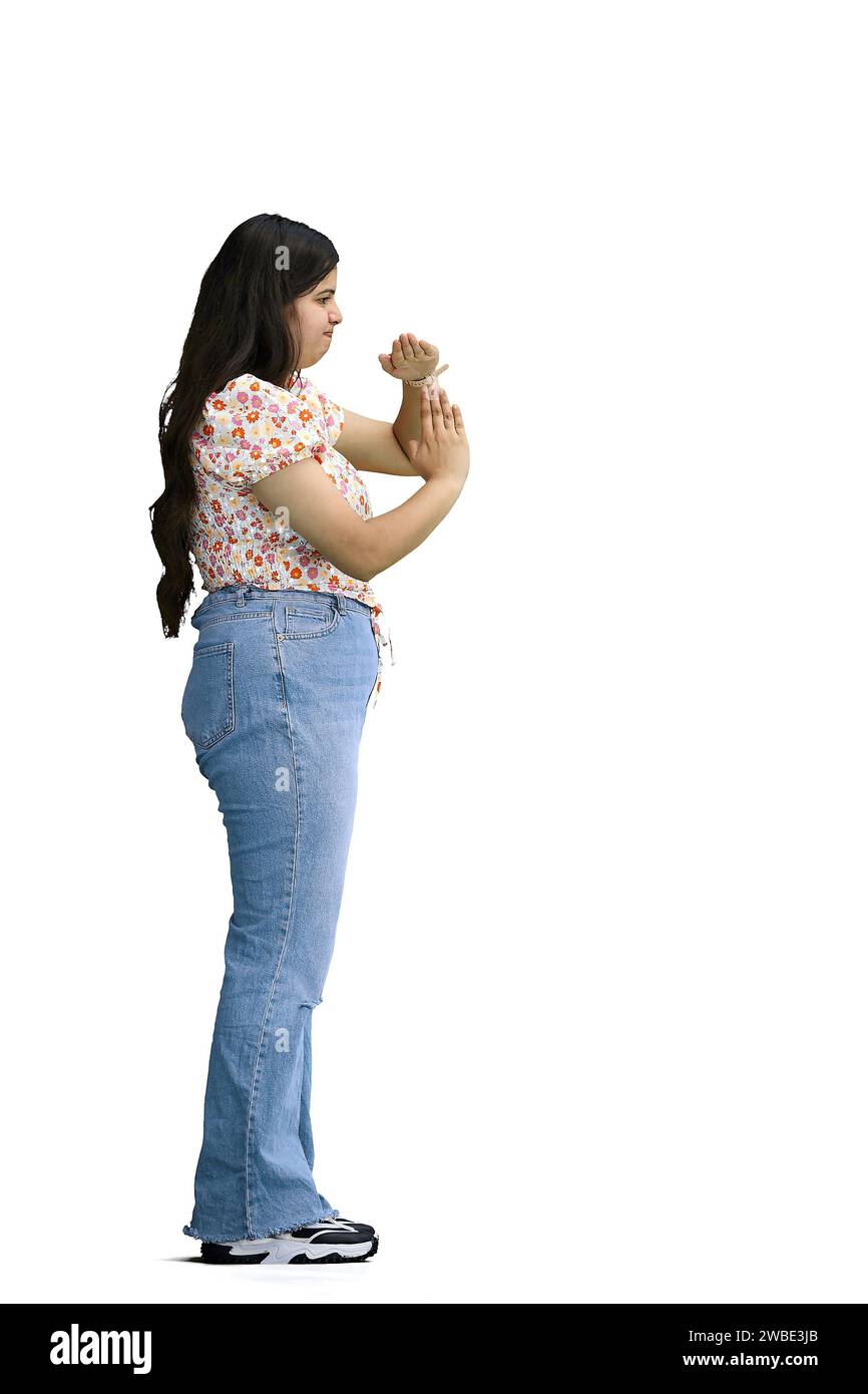 A woman, on a white background, in full height, shows a pause sign ...