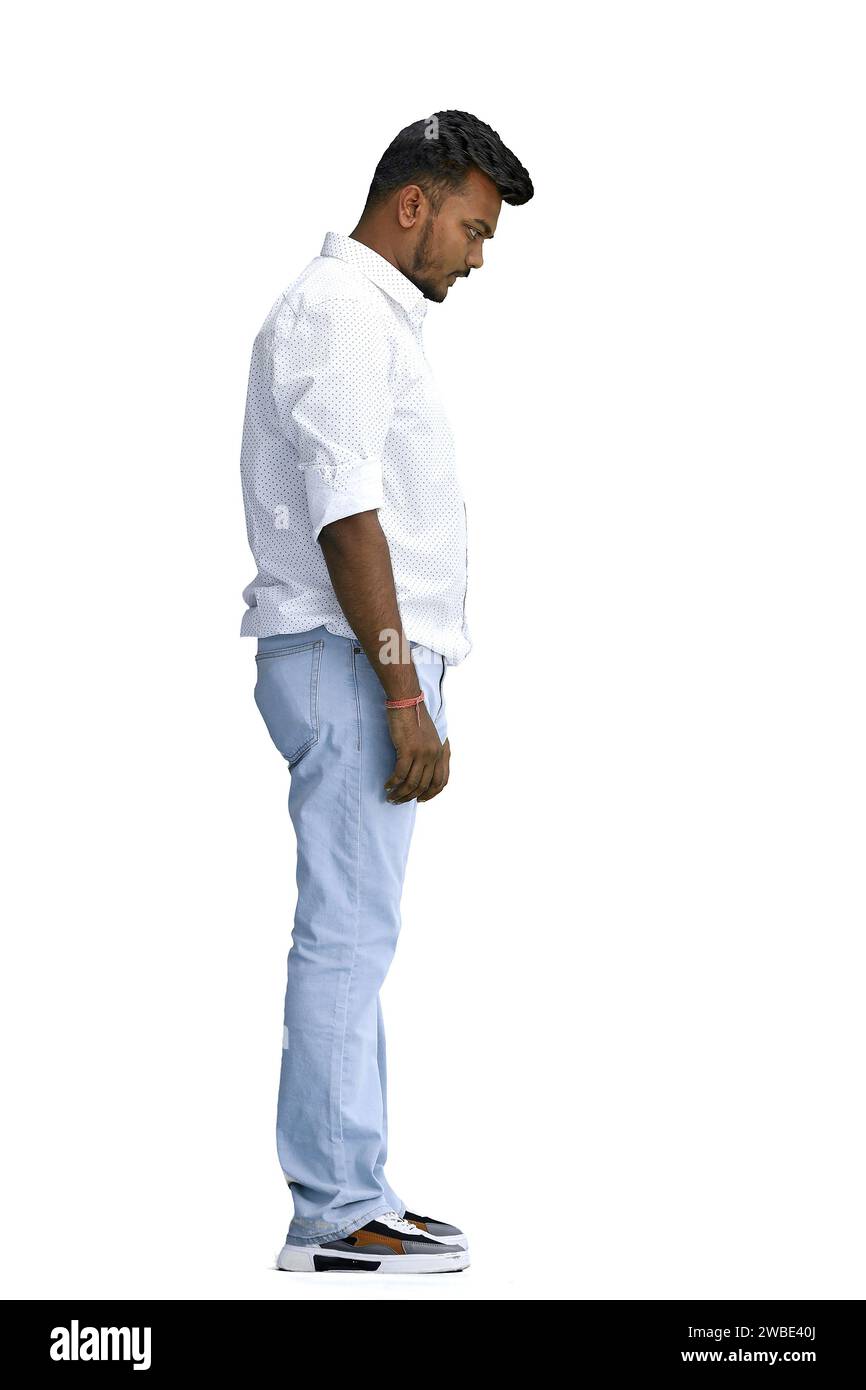 A man in a white shirt, on a white background, in full height, lowered ...