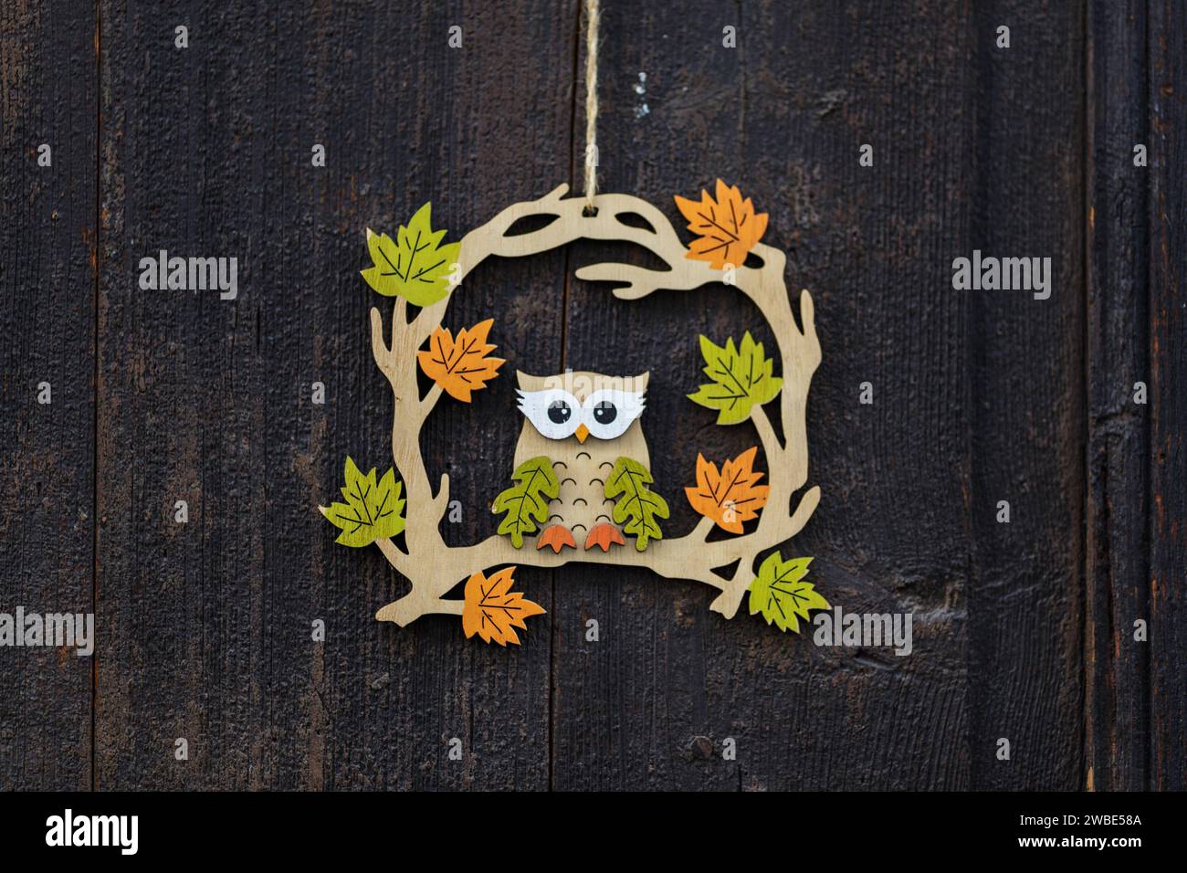 A little wooden owl hanging on a door for decoration in Bad Radkersburg ...