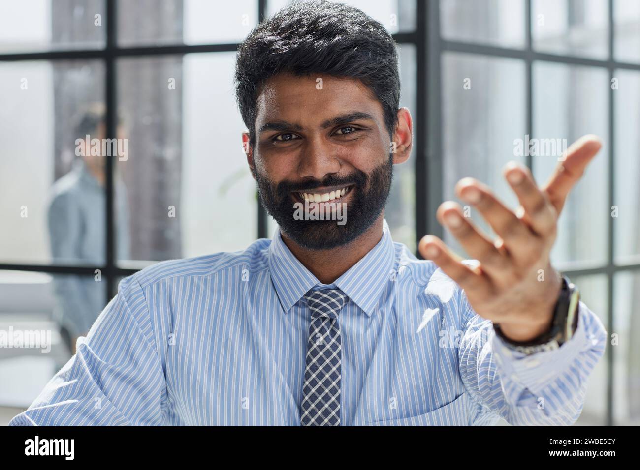 Person inviting you to shake hands before signing the document ...