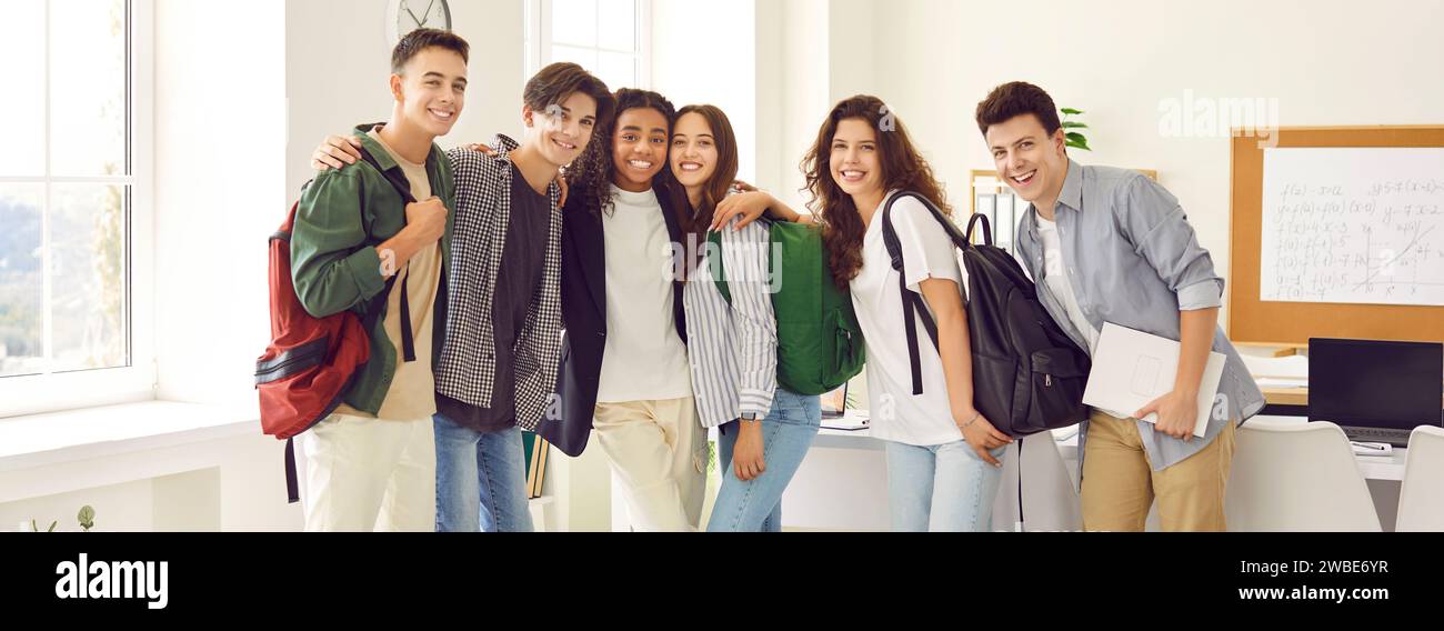Group of a happy school students standing together in classroom and ...