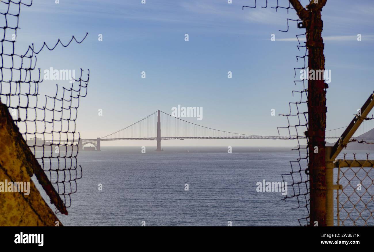 The view of Golden Gate Bridge through a broken chain link fence Stock ...