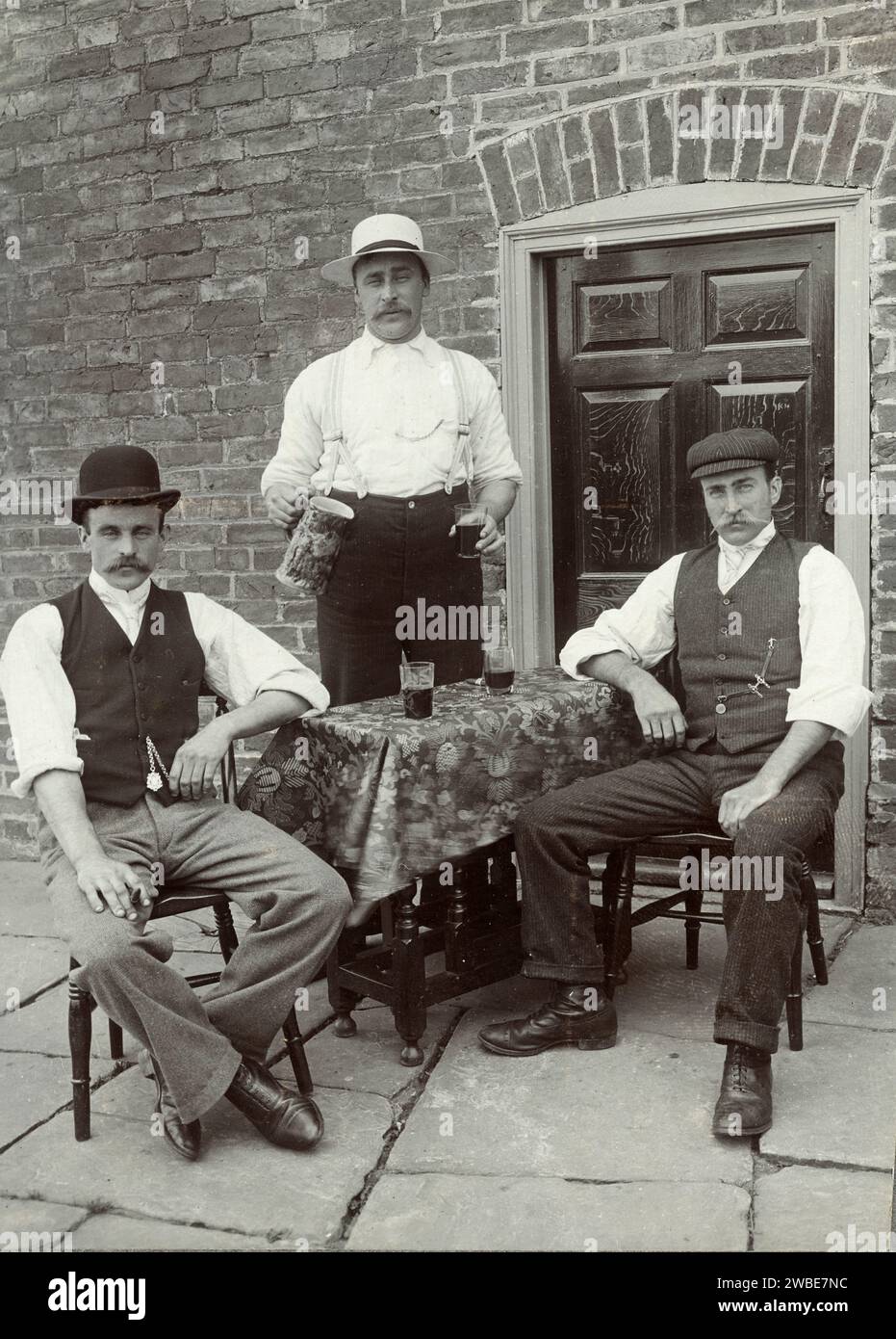 Three British Drinkers or Men Drinking in Street Outside Terraced Brick ...