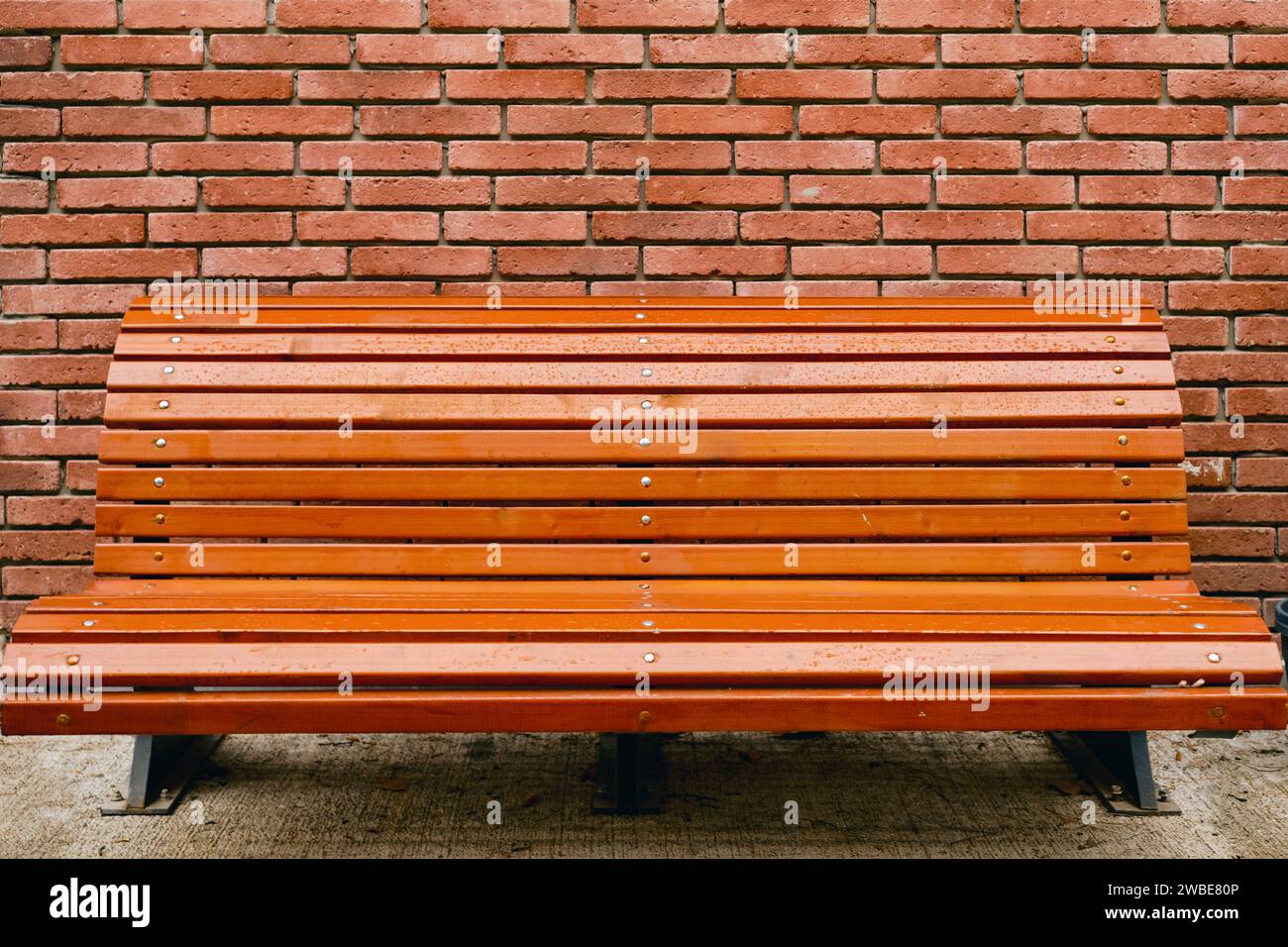 Bench on red brown vintage brick wall texture background, concept ...