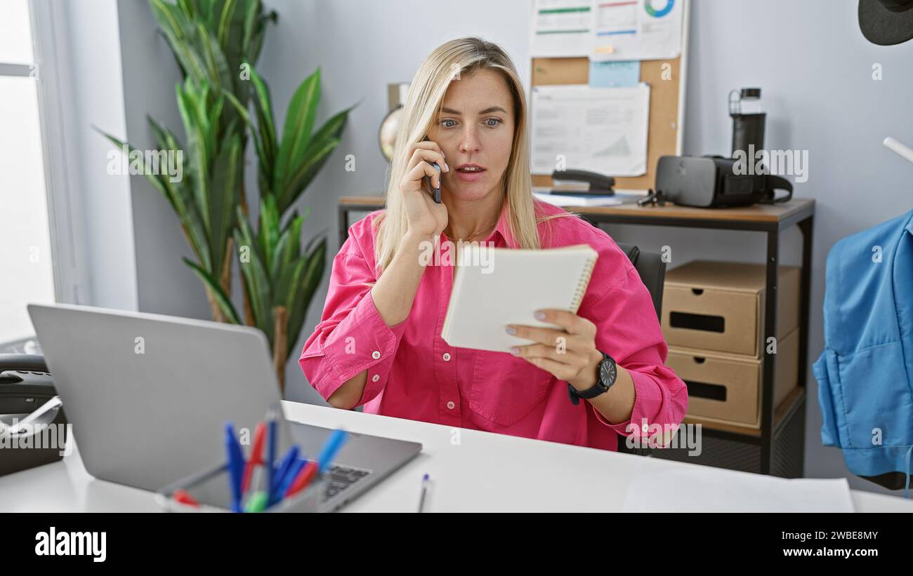 Blonde woman in a pink shirt multitasking with phone and tablet at her ...