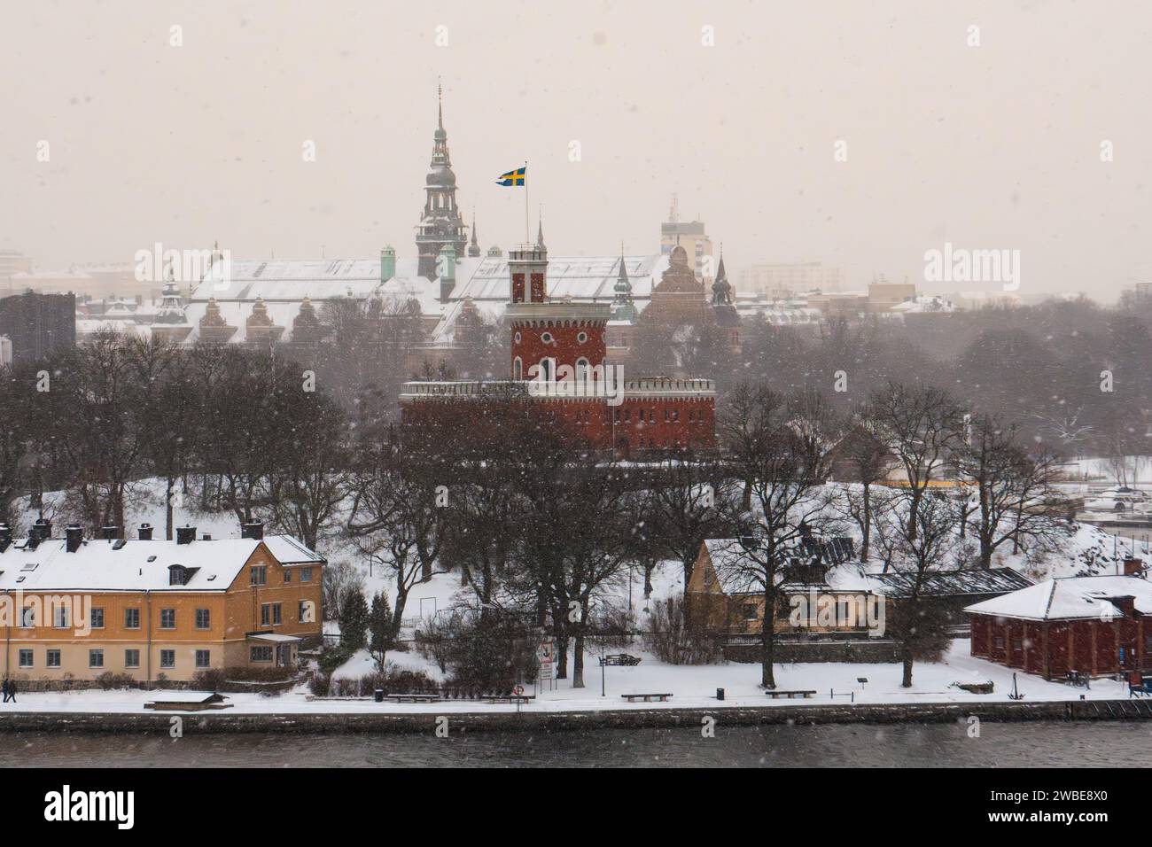 A snowstorm in Stockholm, Sweden. The castle of Kastellet in red on ...