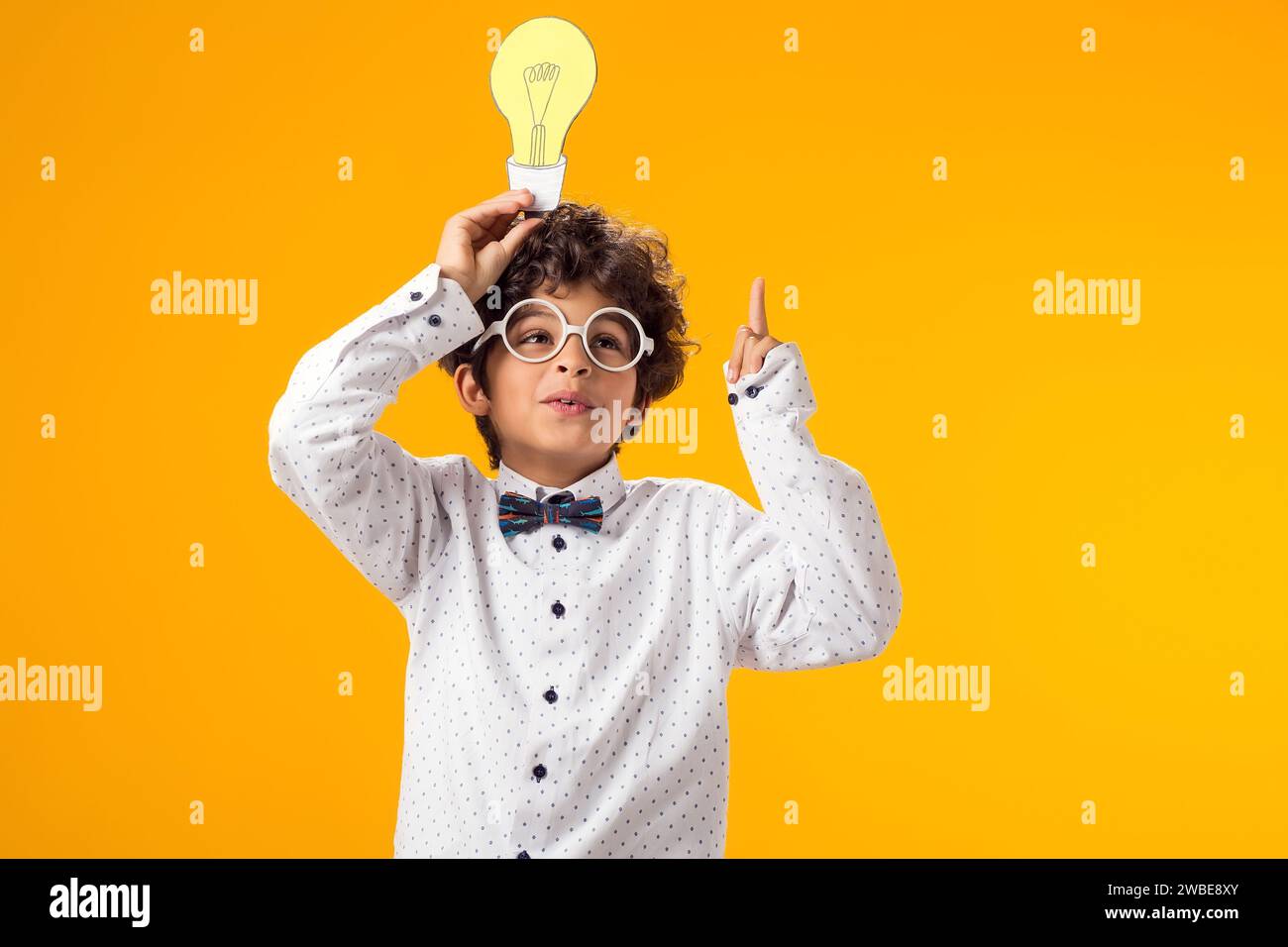Child boy holding paper bulb. Success, motivation, winner, genius, idea ...