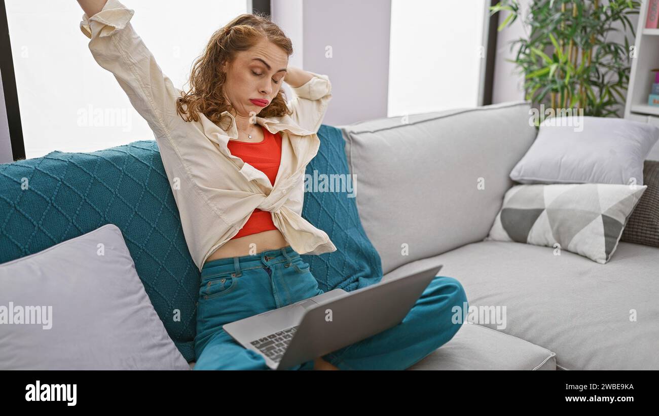 Exhausted young woman relaxing, stretching tired arms back on sofa ...