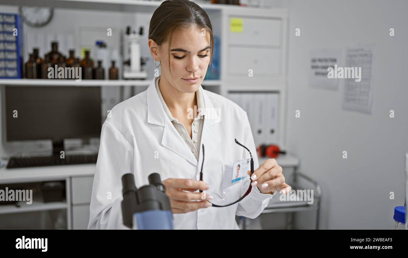 In the heart of the lab, a young, beautiful hispanic woman scientist ...