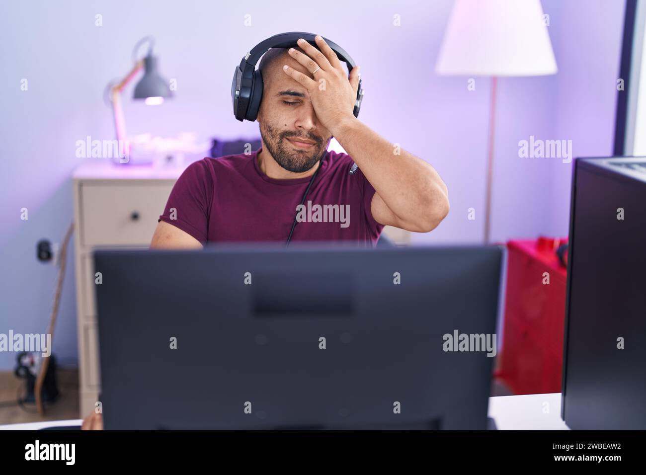 Young latin man streamer stressed using computer at gaming room Stock ...