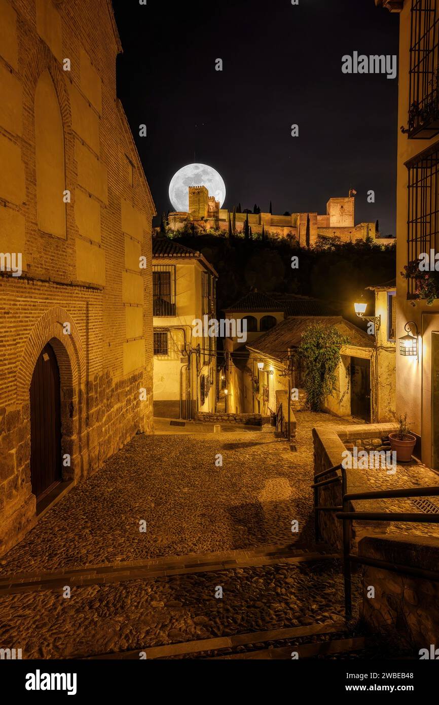 A spectacular full moon rises over the ancient walls of the Alhambra ...