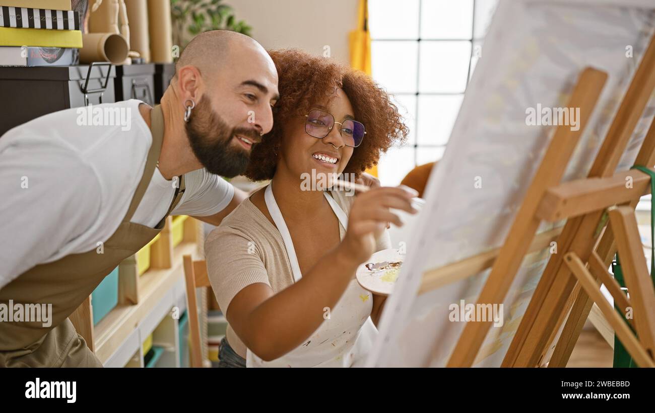 Two artists smiling confident drawing at art studio Stock Photo - Alamy