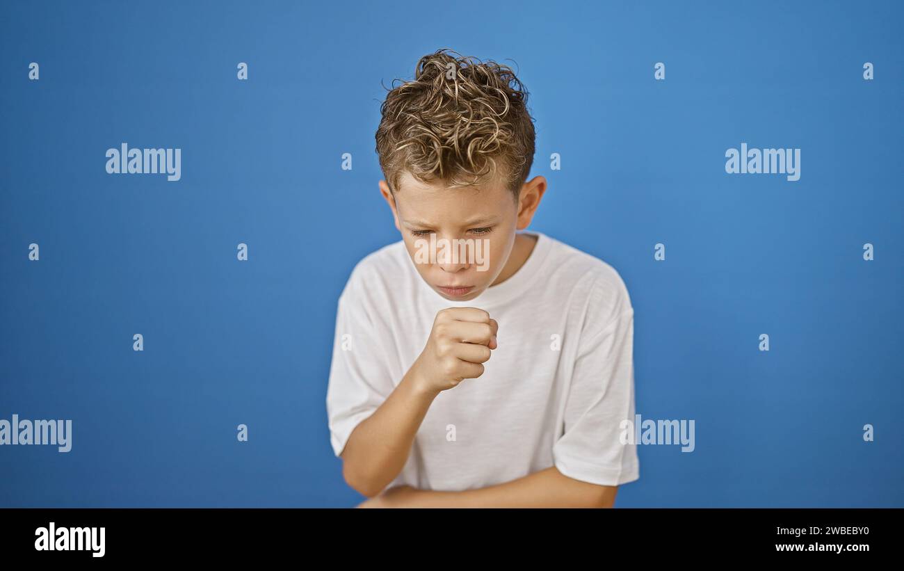 Adorable blond boy, a little sick kid, seriously coughing with flu ...