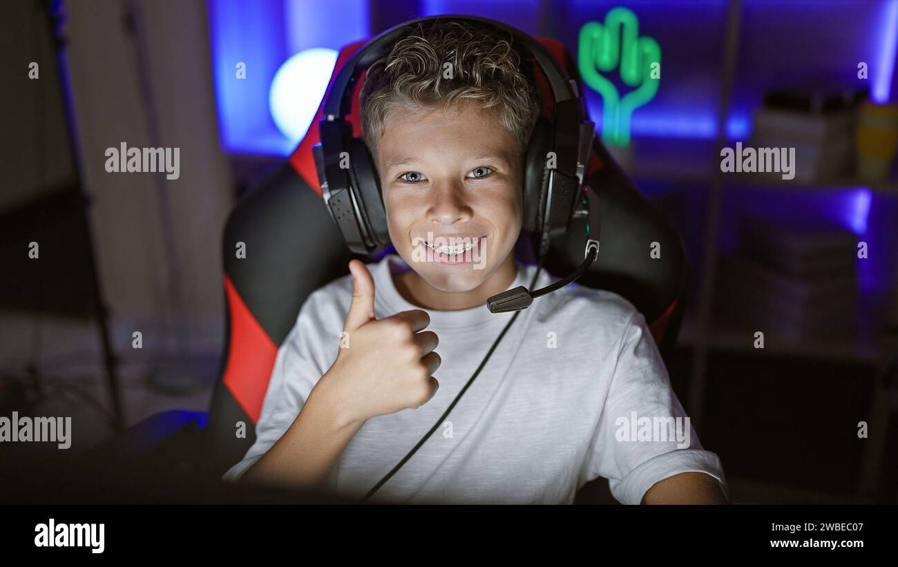 Adorable blond boy streamer gives a thumb up gesture while streaming ...