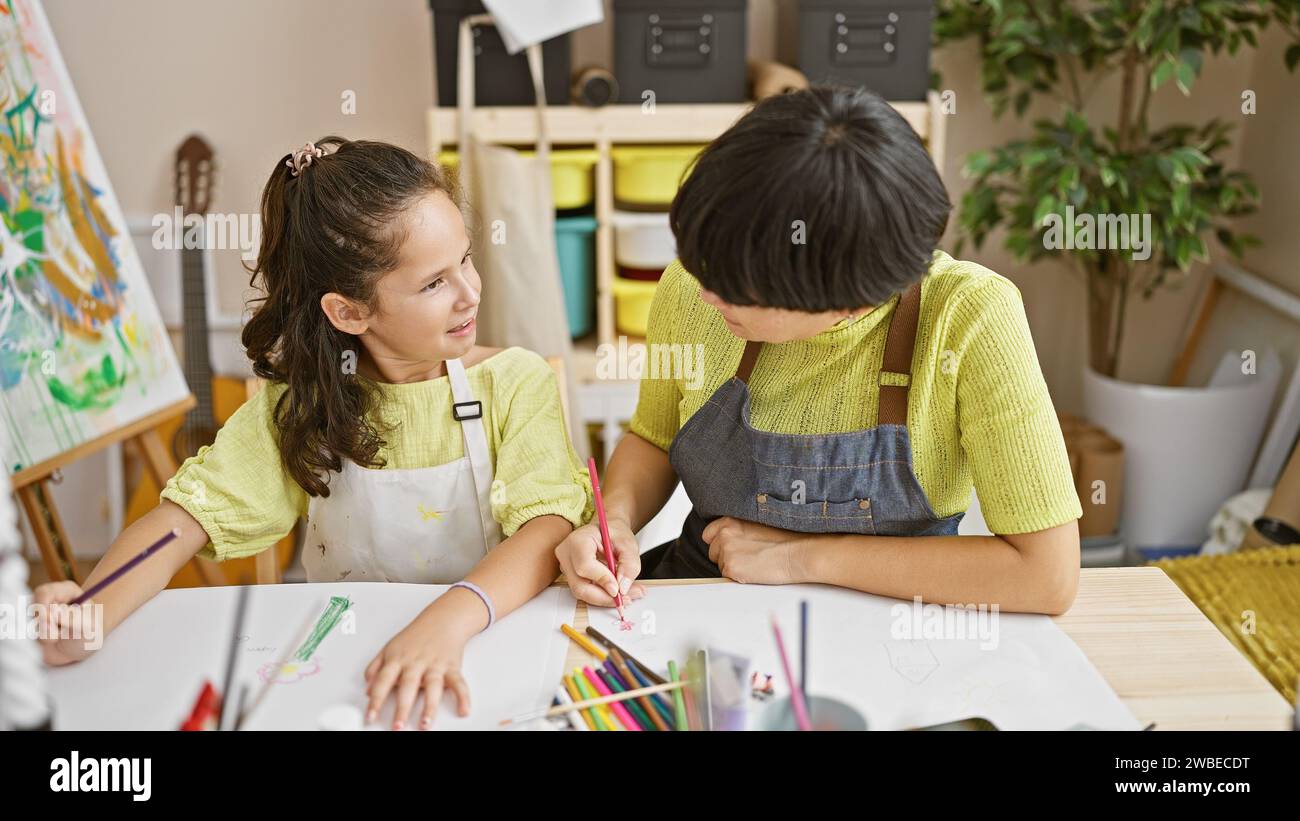Artistic bonding, teacher and student together draw, speaking ...