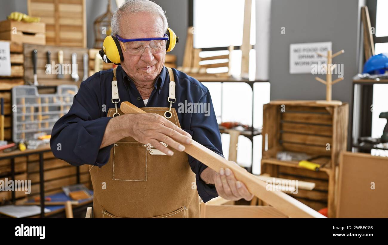 Resilient senior man, a seasoned carpenter, stands firm in his ...