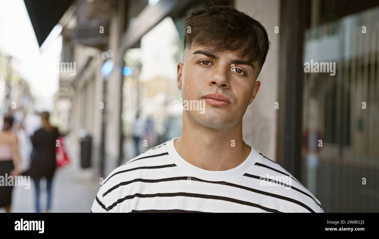 Cool, relaxed young hispanic man, portraying a serious expression while ...