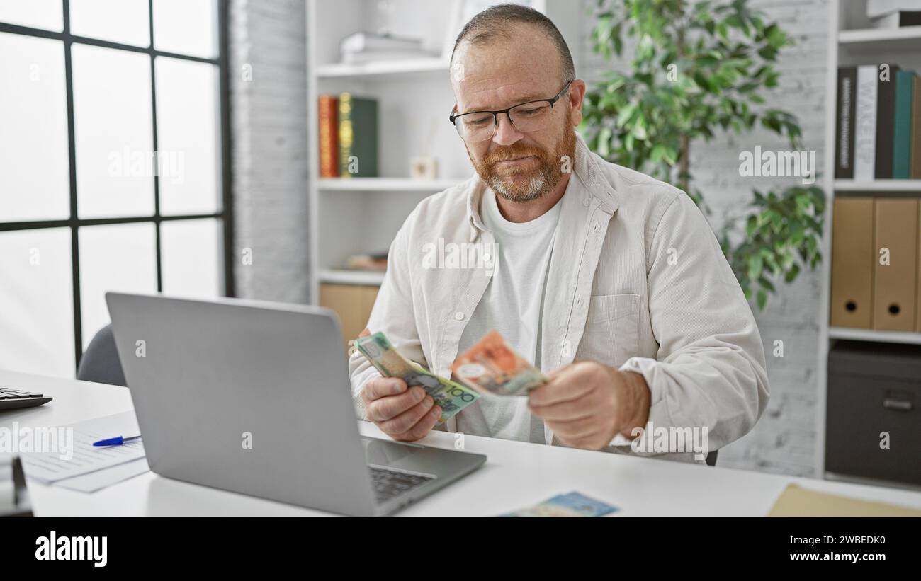 Confident, smiling caucasian man counting australian dollars at his ...